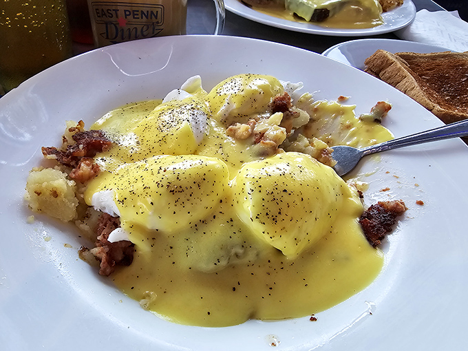 Eggs Benedict done right, with hollandaise so rich it could probably solve most of life's problems.