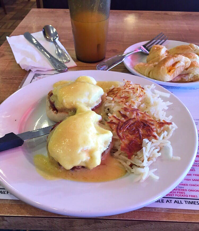 Eggs Benedict: where hollandaise sauce cascades like a yellow waterfall over perfectly poached eggs. The hash browns are just showing off at this point.