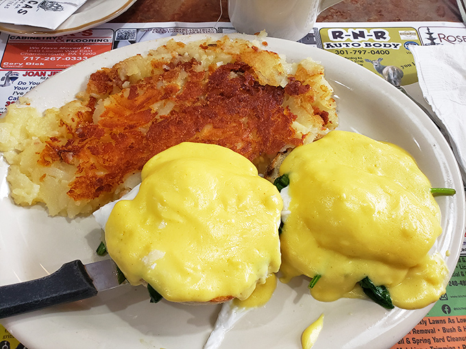 Eggs Benedict done right&mdash;velvety hollandaise cascading over perfectly poached eggs with hash browns crisped to golden-brown perfection.