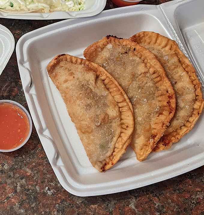 Golden-brown empanadas with perfectly crimped edges are like little treasure chests of flavor. The accompanying salsa is liquid gold.