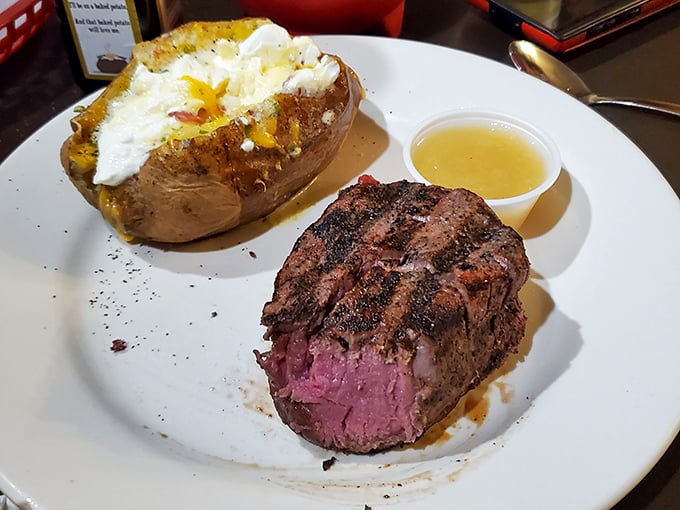 The filet mignon's pink center reveals itself like a sunset breaking through clouds, while that loaded potato threatens to steal the spotlight.