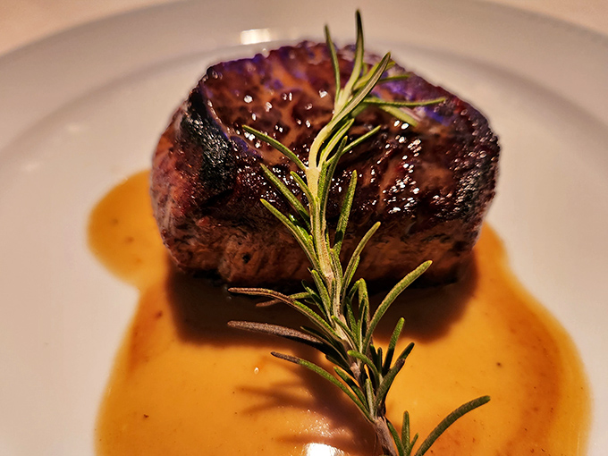 The filet mignon arrives like royalty, crowned with a sprig of rosemary and bathed in a sauce so good you'll contemplate drinking it straight.