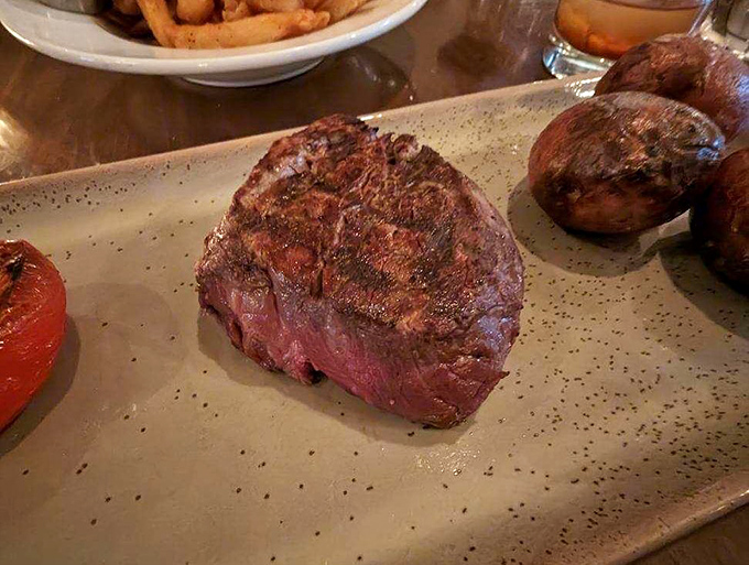 A filet mignon cooked with such respect and precision that somewhere, a cow is feeling oddly honored. Those mushrooms aren't just along for the ride either.