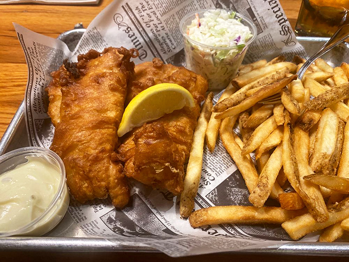 Golden-battered fish that shatters with each bite, served with fries that deserve their own fan club. The newspaper liner is just showing off.