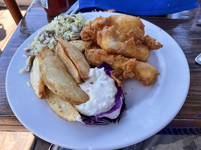 Golden-battered fish and chips with a side of coleslaw that could make a seafood skeptic reconsider their life choices in one crispy, flaky bite.
