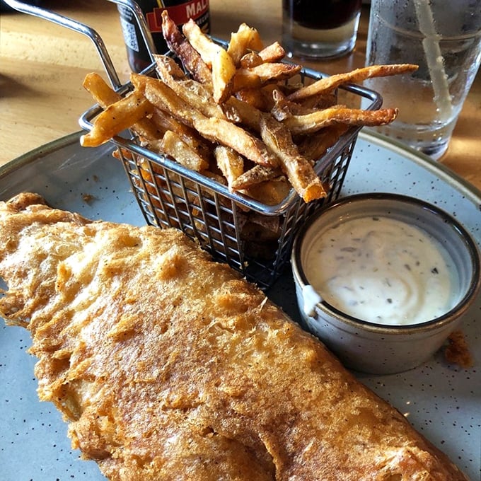 Fish and chips that would make a British pub jealous, with a golden batter so crisp you can practically hear it crackle through the photo.