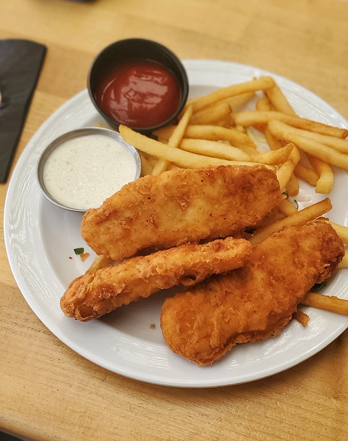 Golden-battered fish that shatters at first bite, paired with fries that could make a Frenchman weep with joy.