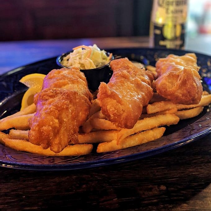 Beer-battered fish that's crispier than your grandpa's jokes, served atop a bed of fries. The kind of comfort food that makes Midwest winters bearable.