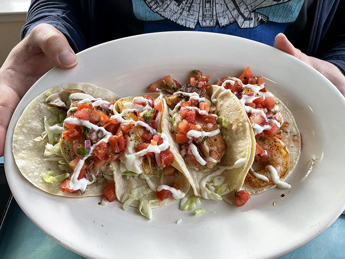 Fish tacos that tell the perfect California story: fresh catch nestled in corn tortillas, topped with a confetti of pico de gallo and a drizzle of crema.