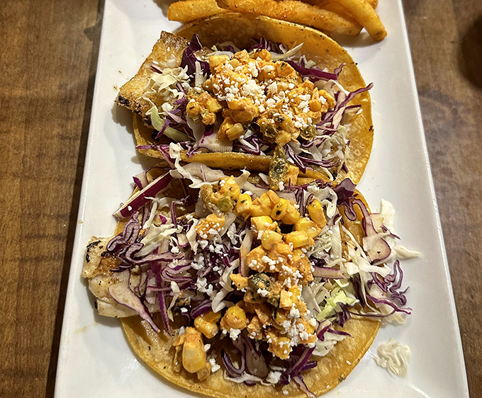 Fish tacos that make you question why you ever settled for lesser versions&mdash;vibrant slaw and crumbled cheese creating a perfect coastal symphony.