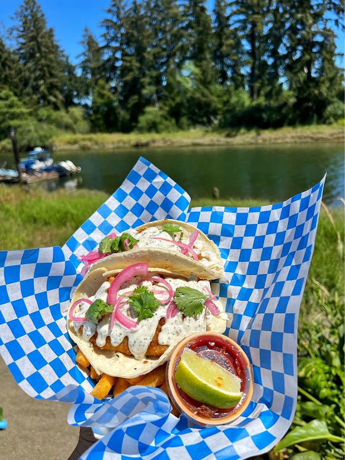 Fish tacos with a view that could make a postcard jealous&mdash;pink onions and creamy sauce adding pops of color that match the scenery's splendor.