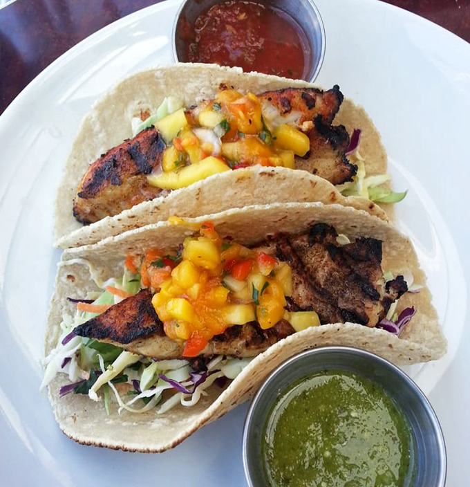 Fish tacos that bridge cultures and flavors &ndash; grilled perfection topped with vibrant mango salsa that makes your taste buds feel like they're on a tropical vacation.