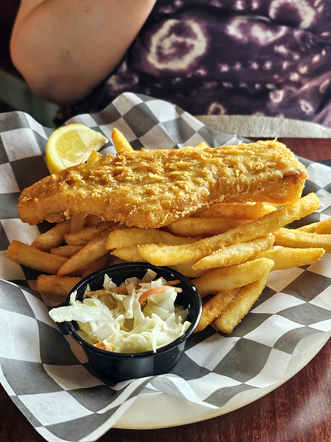 Golden-battered fish and crispy fries that would make a British pub jealous, served with the kind of coleslaw that converts skeptics.