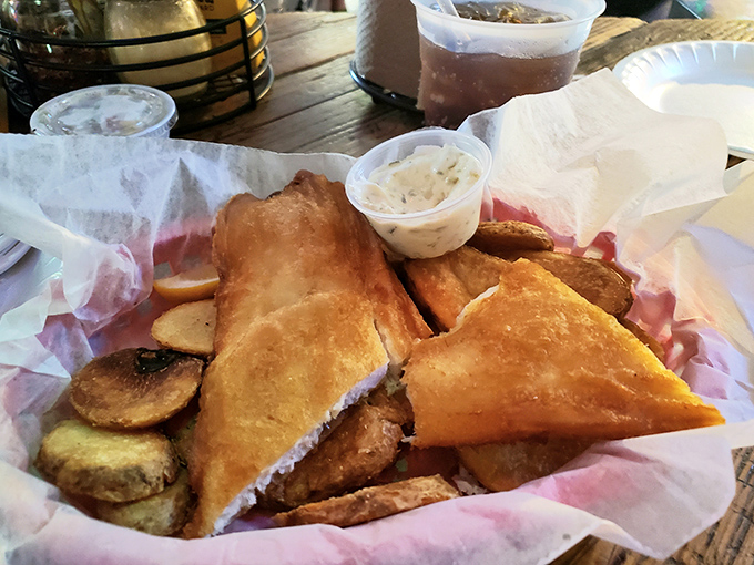 Golden-fried fish that crunches like autumn leaves, nestled beside fries that could make a potato proud. Simple perfection.