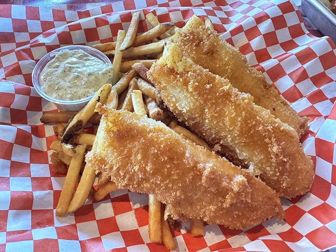 Golden-battered fish that cracks perfectly with each bite, served with fries that deserve equal billing in this classic seaside duo.
