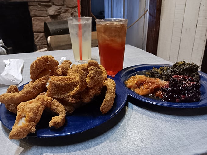 Cornmeal-crusted catfish stands guard next to collard greens and cobbler – a Southern trinity that demands reverence and loose-fitting pants.
