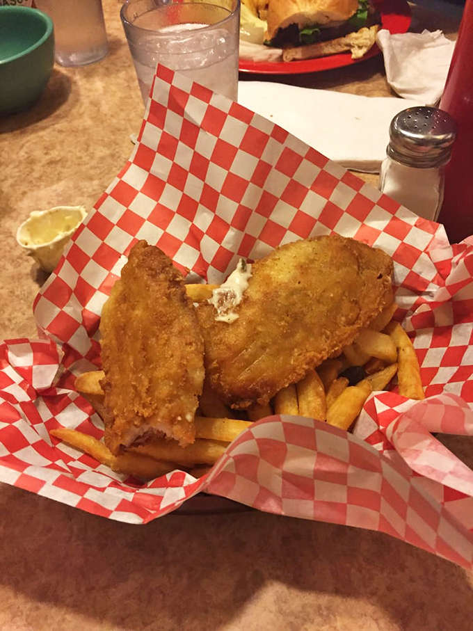 Fish and chips served in the classic red-checkered basket &ndash; crispy, golden comfort that tastes like vacation even on a Tuesday afternoon.