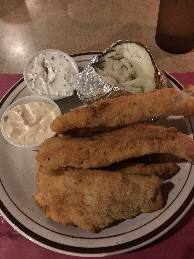 Golden-fried fish with a baked potato wrapped in foil like a delicious present. Wisconsin's fish fry tradition elevated to an art form.