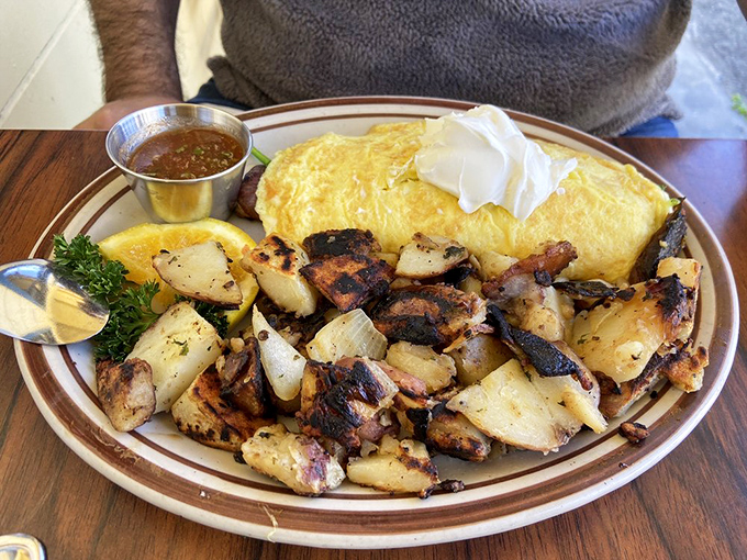 Potatoes crisped to that magical point between hash and heaven. Paired with an omelet so fluffy it practically needs its own weather system.