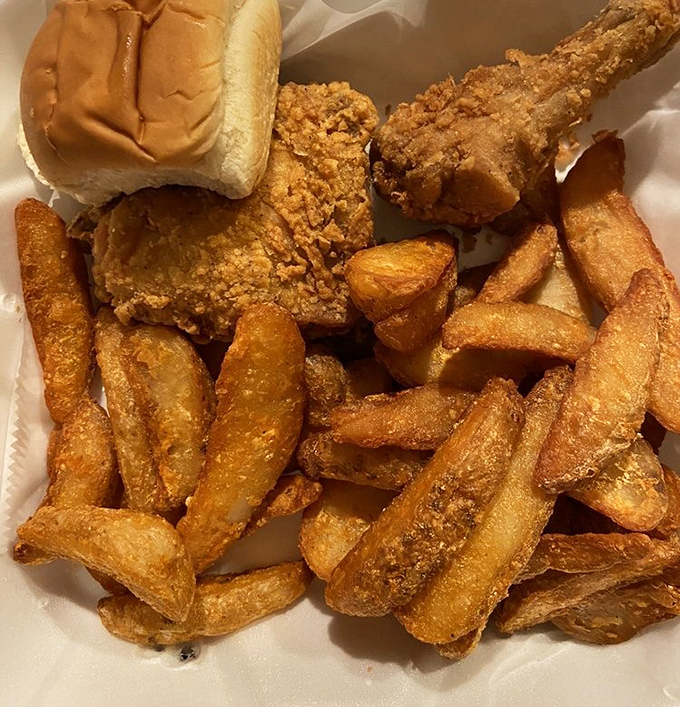 The holy trinity of comfort: golden fries, crispy chicken, and a soft roll standing by. This isn't a meal&mdash;it's a warm hug on a plate.