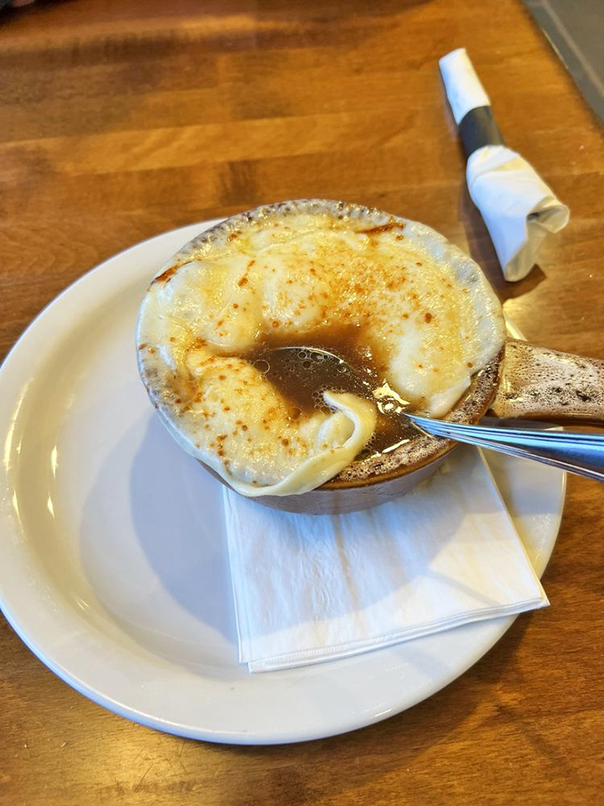 This French onion soup isn't playing games &ndash; the melted cheese stretches dramatically with each spoonful, while the rich broth delivers pure satisfaction.v