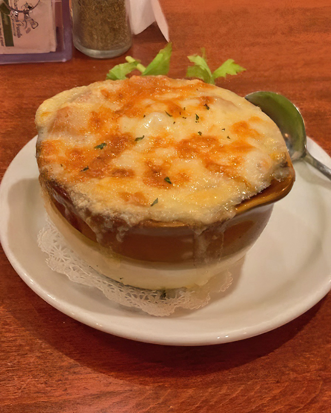 This isn't just soup&mdash;it's a French onion masterpiece with a golden cheese cap that stretches dramatically with each spoonful, making neighboring diners watch with envy.