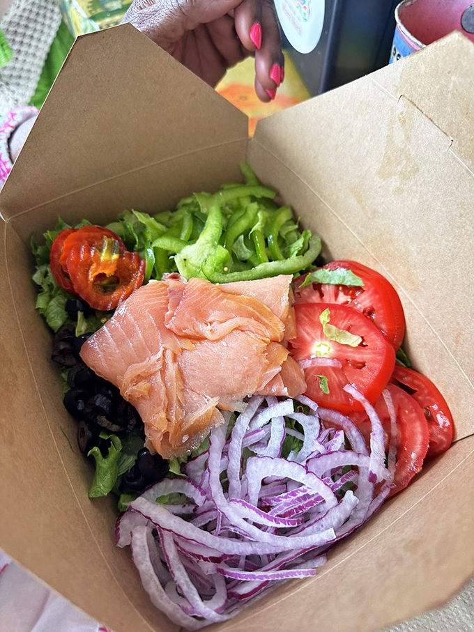 Salmon that looks like it was swimming upstream just moments ago, nestled among vegetables so fresh they're practically photosynthesizing on your plate.