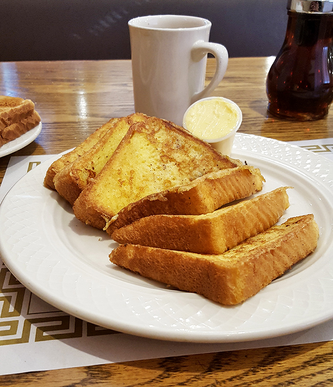 French toast that's dressed for success. Perfect golden slices stand at attention, ready to soak up whatever syrup situation you throw their way.
