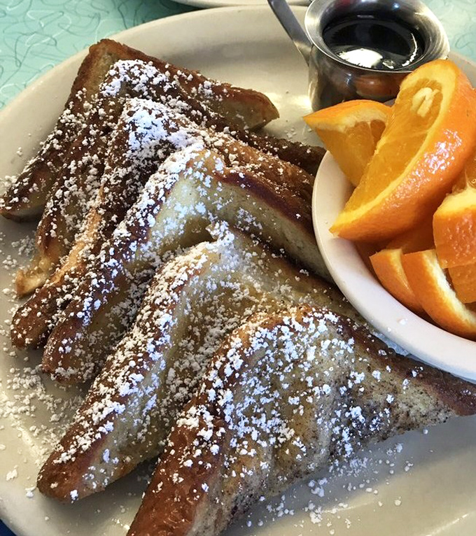 French toast that makes you question every other breakfast you've ever had. That powdered sugar dusting? Pure showmanship.