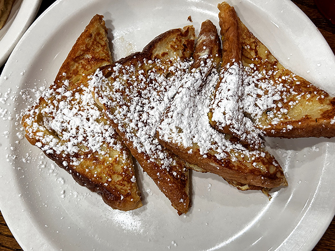 French toast dusted with powdered sugar like the first snow of winter. Crisp edges, custardy center &ndash; breakfast's perfect middle ground.