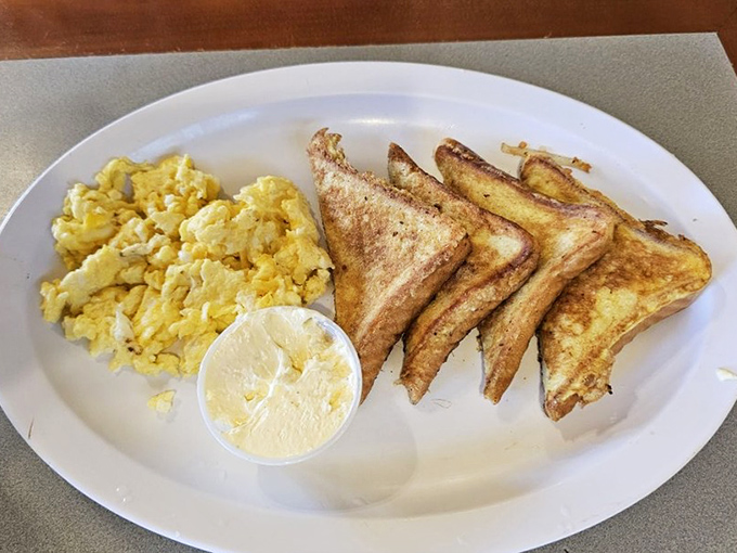 Simple pleasures done perfectly: golden toast, fluffy scrambled eggs, and a dollop of butter that melts just watching it.