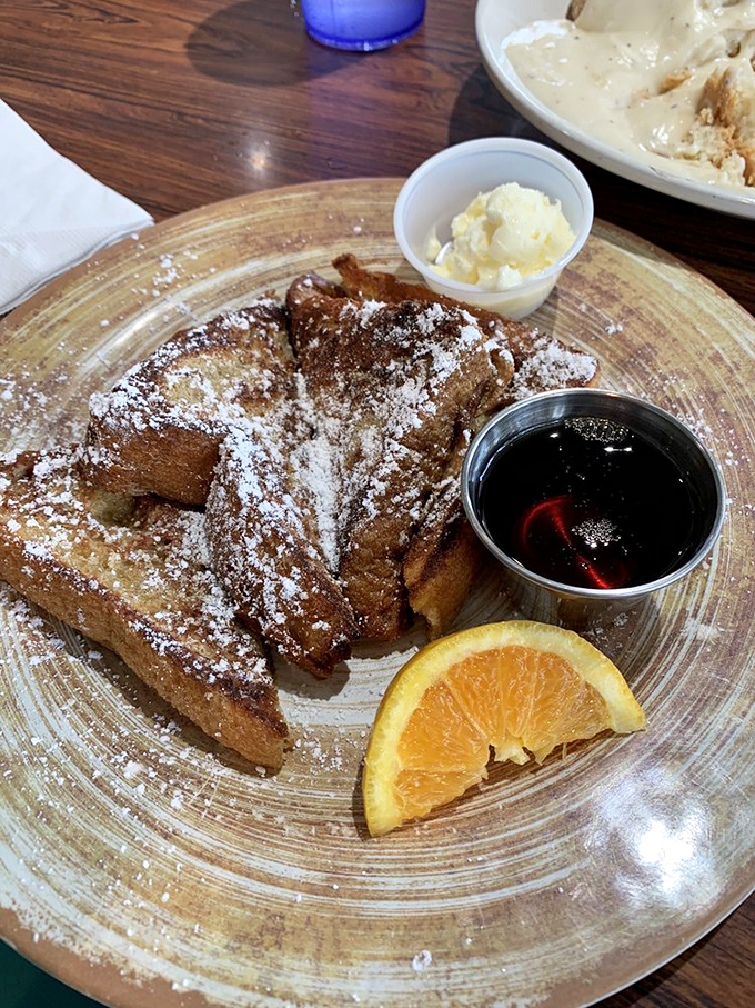 French toast that's achieved that magical balance between crispy exterior and custardy interior. The powdered sugar snowfall is just showing off.