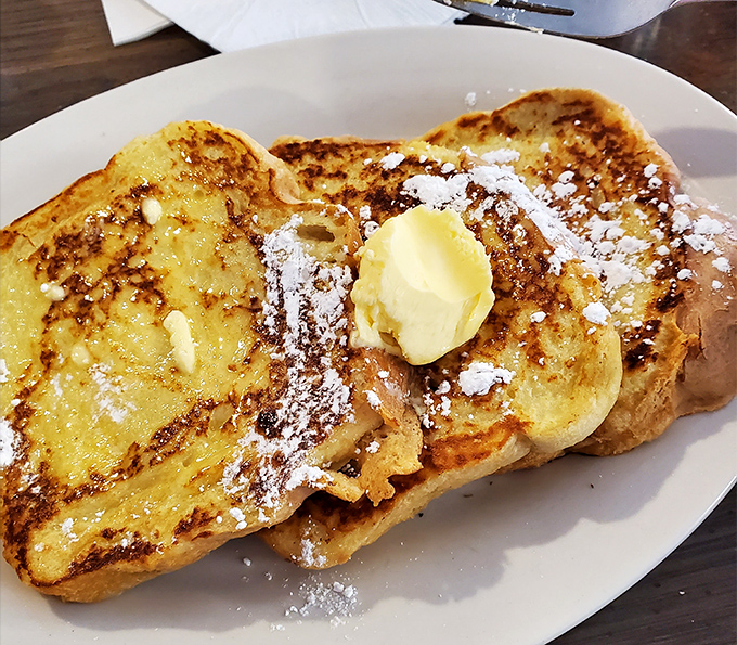French toast so golden it could've been kissed by Midas himself, with butter melting like morning sunshine.