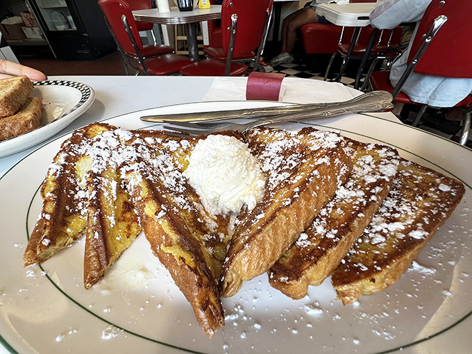 French toast that's achieved the perfect custard-to-crisp ratio, dusted with powdered sugar like fresh snow on Christmas morning.