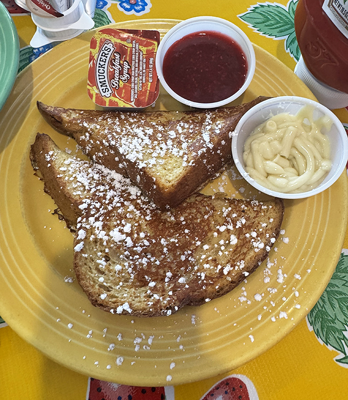 French toast dusted with powdered sugar like fresh snow on golden breakfast mountains of pure indulgence.