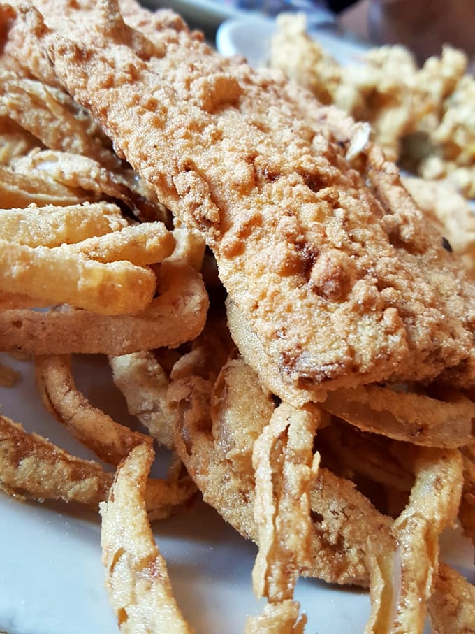 Perfectly fried haddock with a crust that shatters like thin ice, revealing flaky white fish that practically melts on your tongue.