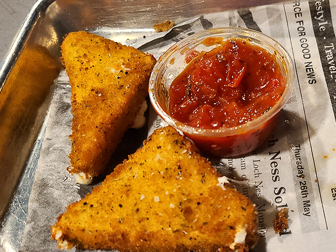 Golden triangles of joy that make mozzarella sticks elsewhere seem like distant relatives who never call. The perfect crisp-to-gooey ratio is culinary mathematics at its finest.