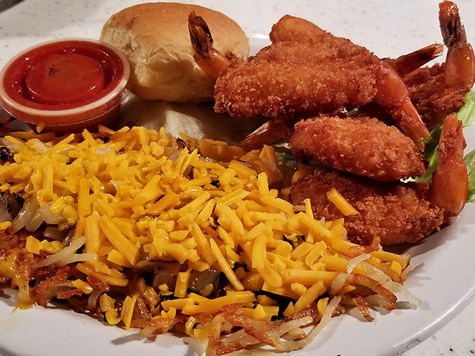 Whoever decided to pair golden-fried shrimp with cheese-topped hashbrowns deserves a Nobel Prize in comfort food engineering.