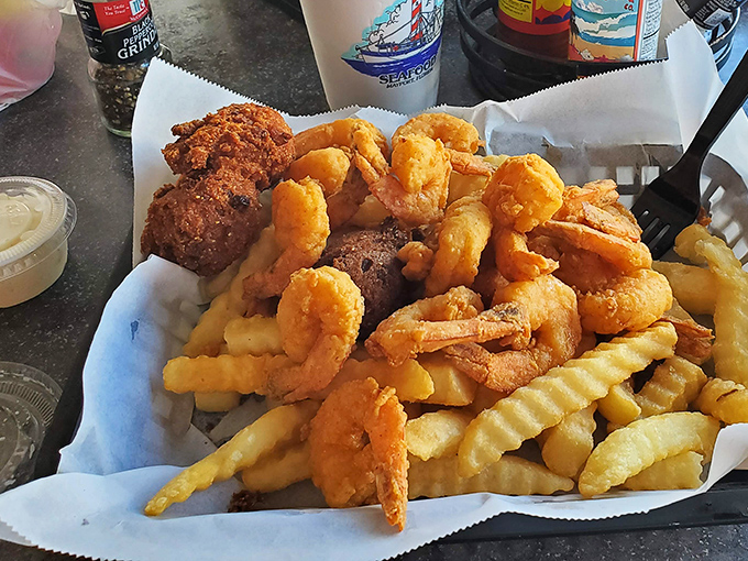 A mountain of golden fried shrimp atop crispy fries&mdash;proof that sometimes the simplest pleasures are the most profound. The seafood equivalent of a standing ovation.