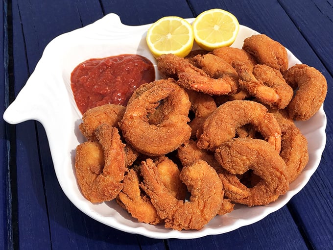 Golden-fried shrimp that crunch like autumn leaves, revealing sweet, tender interiors that would make Neptune himself put down his trident for a taste.