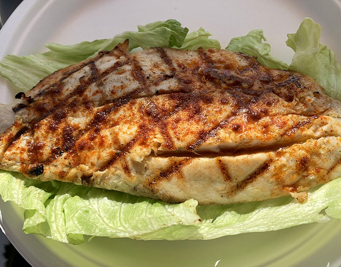 Grilled fish that proves not everything delicious needs a crispy coating. Char marks like nature's signature on a masterpiece of simplicity.