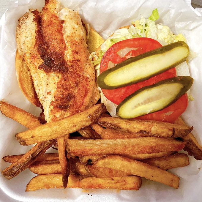 A sandwich that captures the essence of Florida &ndash; grilled grouper, fresh veggies, and those gloriously crispy fries that demand to be savored.