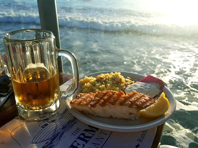 Grilled fish with a view that's equally delicious. When your dinner backdrop is crashing waves, even the beer tastes better.
