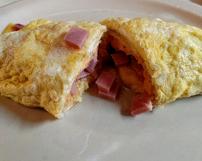 Ham and cheese, the Astaire and Rogers of the omelet world, dancing perfectly together in this golden package.