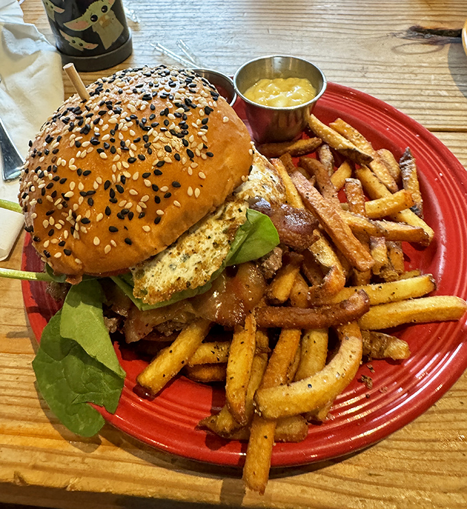 This isn't just a burger&mdash;it's an architectural marvel of sesame-studded bun, perfectly seared patty, and fresh greens that somehow manages to stay together until the last bite.