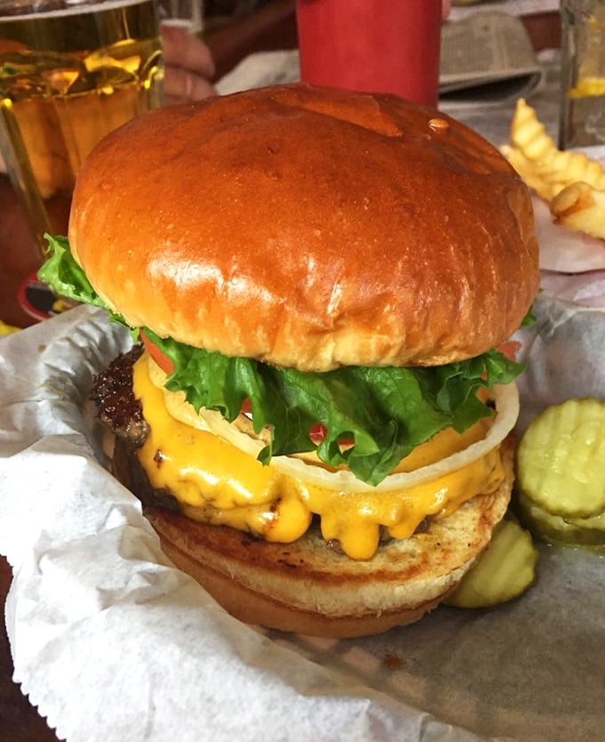 This isn't just a burger&mdash;it's an architectural marvel of beef, cheese, and fresh toppings that requires both hands and possibly a strategic eating plan.