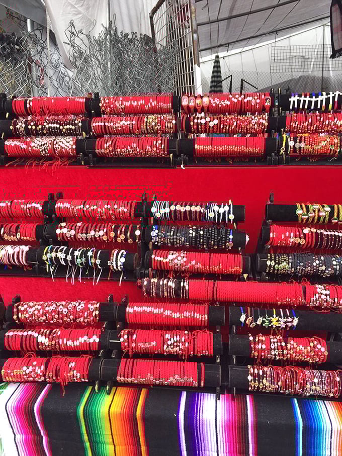 A kaleidoscope of red bracelets awaits new wrists. Some call it fashion; I call it the ultimate souvenir that won't collect dust.