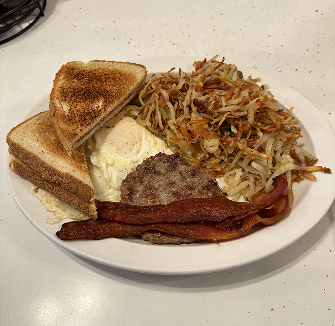 Breakfast of champions! Crispy hash browns with that perfect golden crust, eggs, bacon, and toast—the four food groups of happiness.