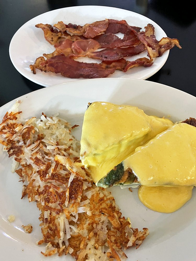 Eggs Benedict that would make your grandmother proud, with hollandaise so yellow it could brighten even Monday mornings. Crispy hash browns play the perfect supporting role.