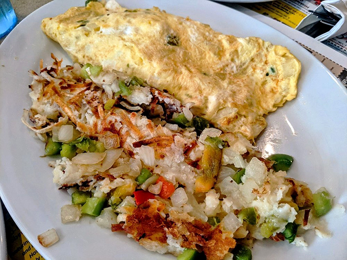 An omelet that's seen things, flanked by home fries that achieved the impossible&mdash;crispy exterior, fluffy interior. The breakfast equivalent of winning the lottery. 